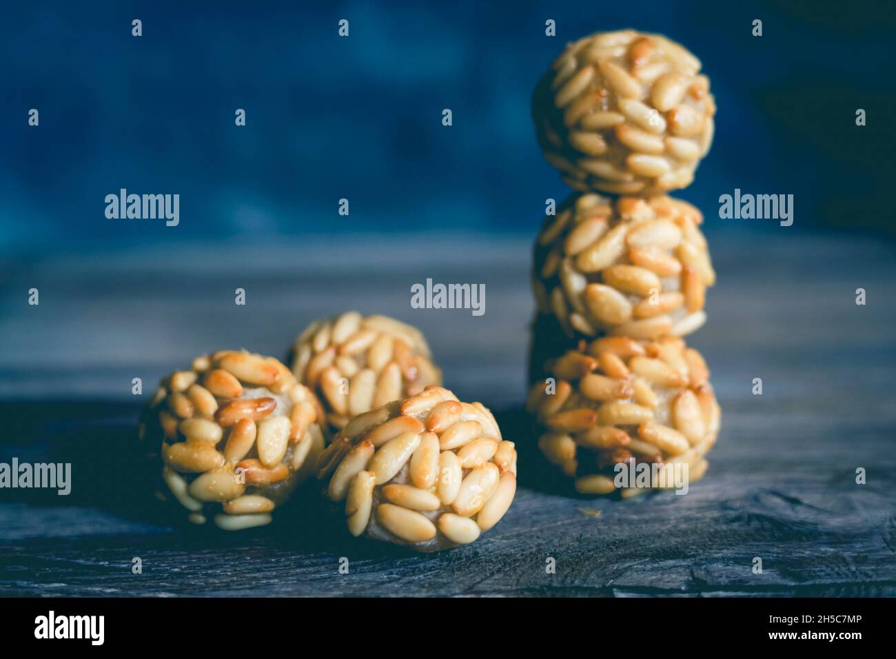 Stack of traditional Catalonian panellets with pine nuts on a table ...