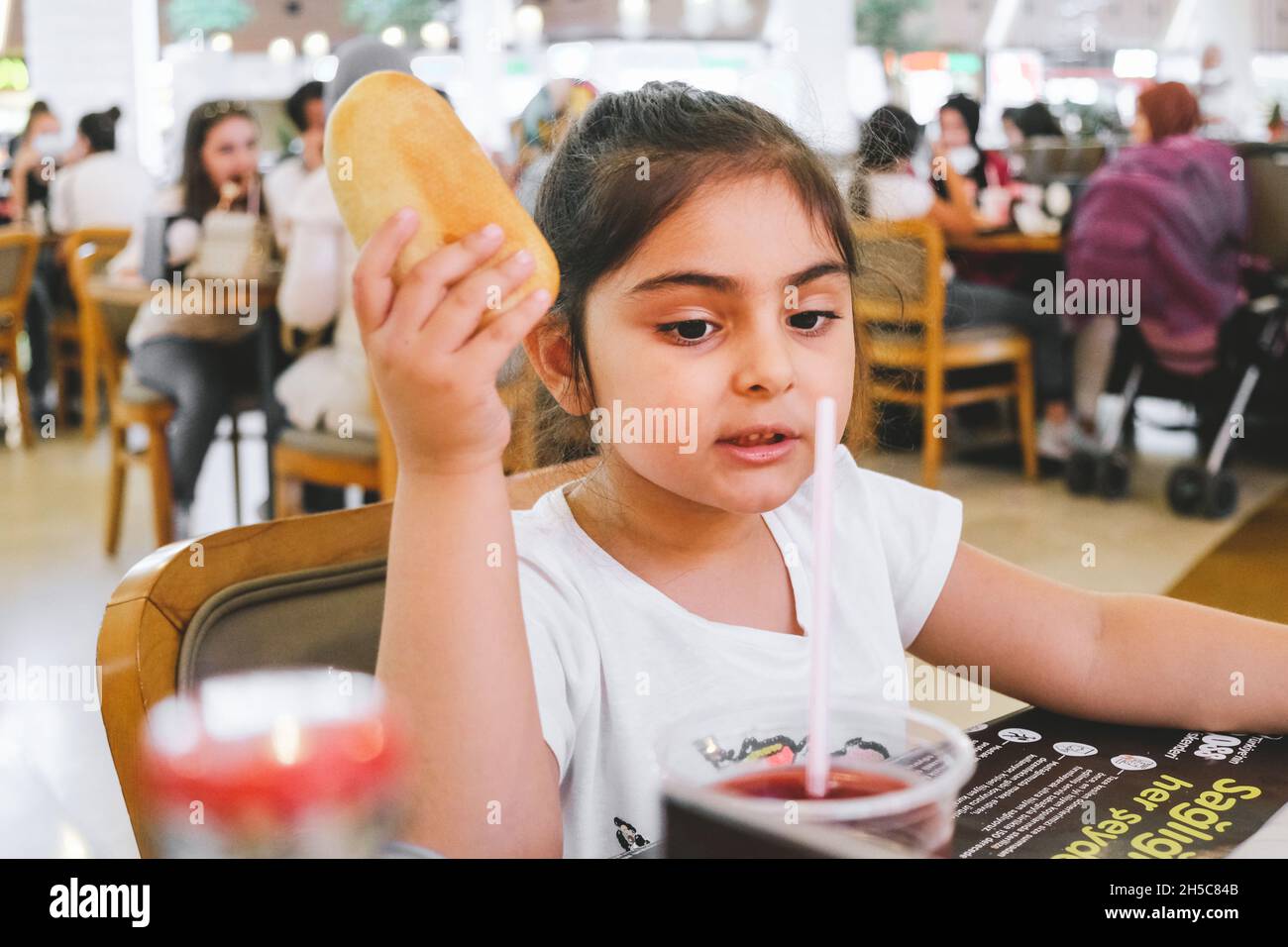 ISTANBUL, TURKEY - Sep 19, 2021: A young girl in an outdoor restaurant ...