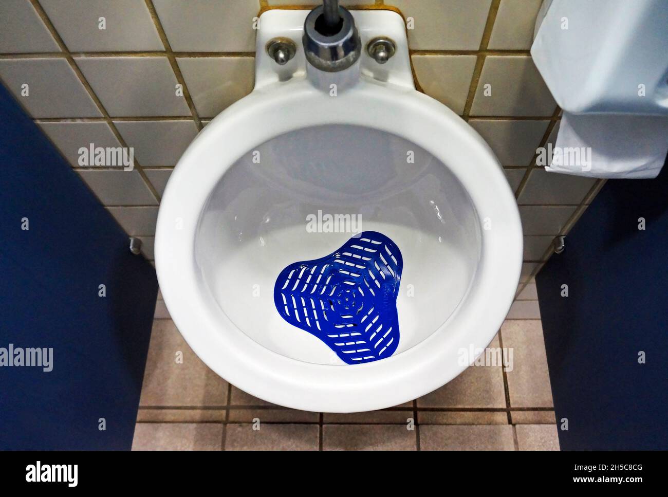 White porcelain urinal in public toilet Stock Photo - Alamy