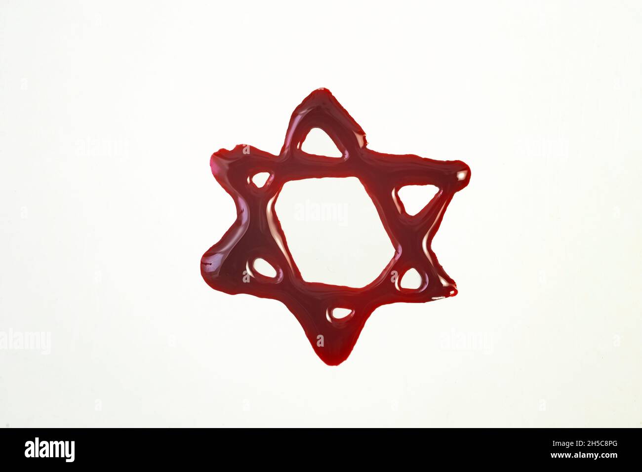 David's star made with blood on white background. Selective focus macro ...