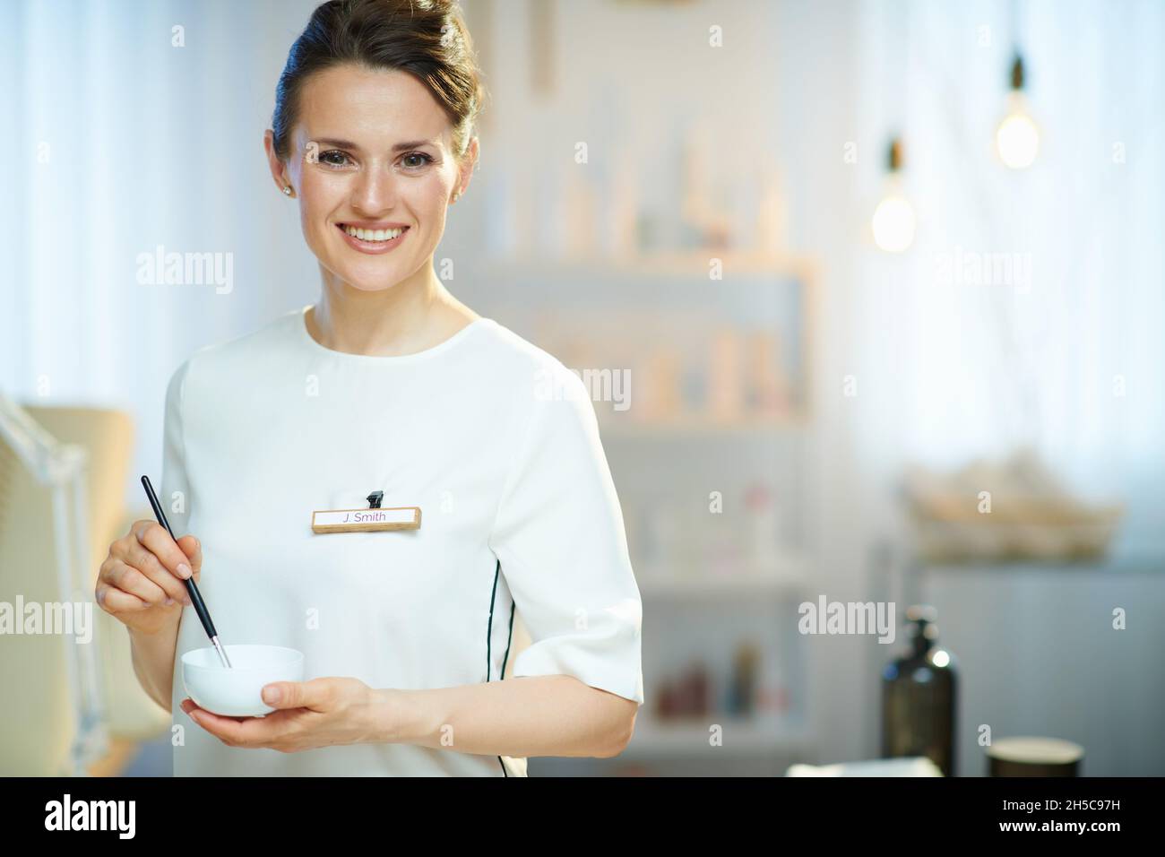 happy 40 years old woman employee in modern beauty studio working Stock ...