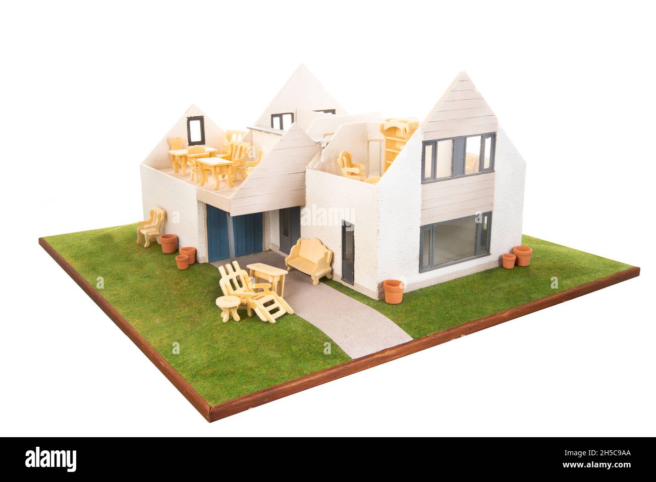 Miniature house with furniture isolated over white background Stock ...
