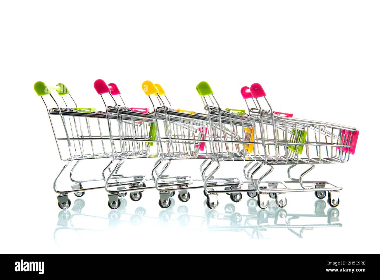 Row empty shopping carts isolated white background Stock Photo - Alamy