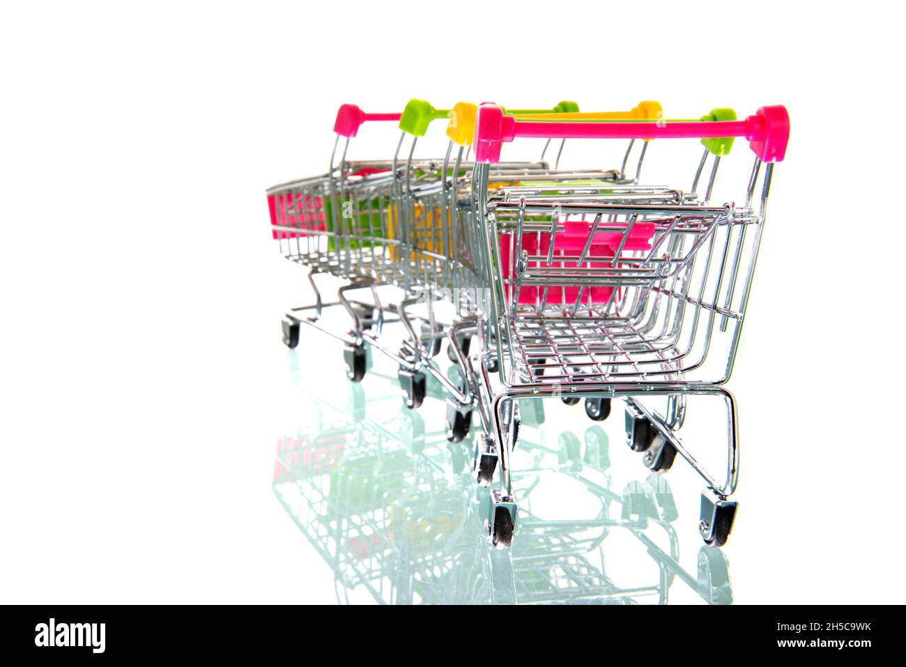Row empty shopping carts isolated white background Stock Photo - Alamy