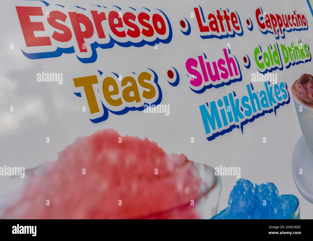 large colourful advertising sign for drinks at a seaside refreshments ...