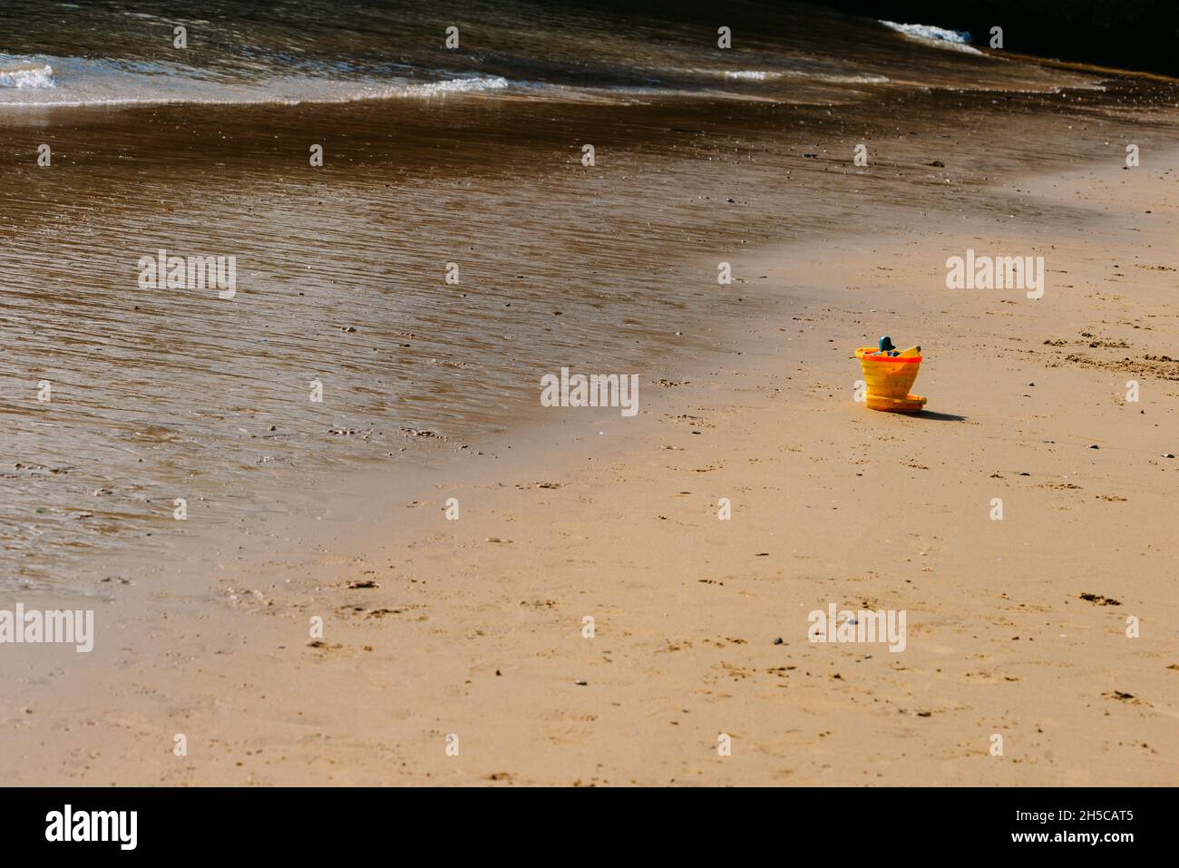 Small bucket on the sandy beach Stock Photo - Alamy