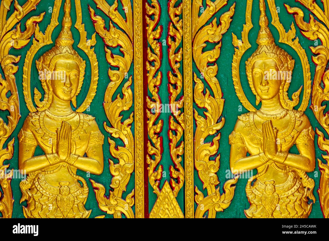 two deities, golden relief buddhas, golden thai deity, thailand ...