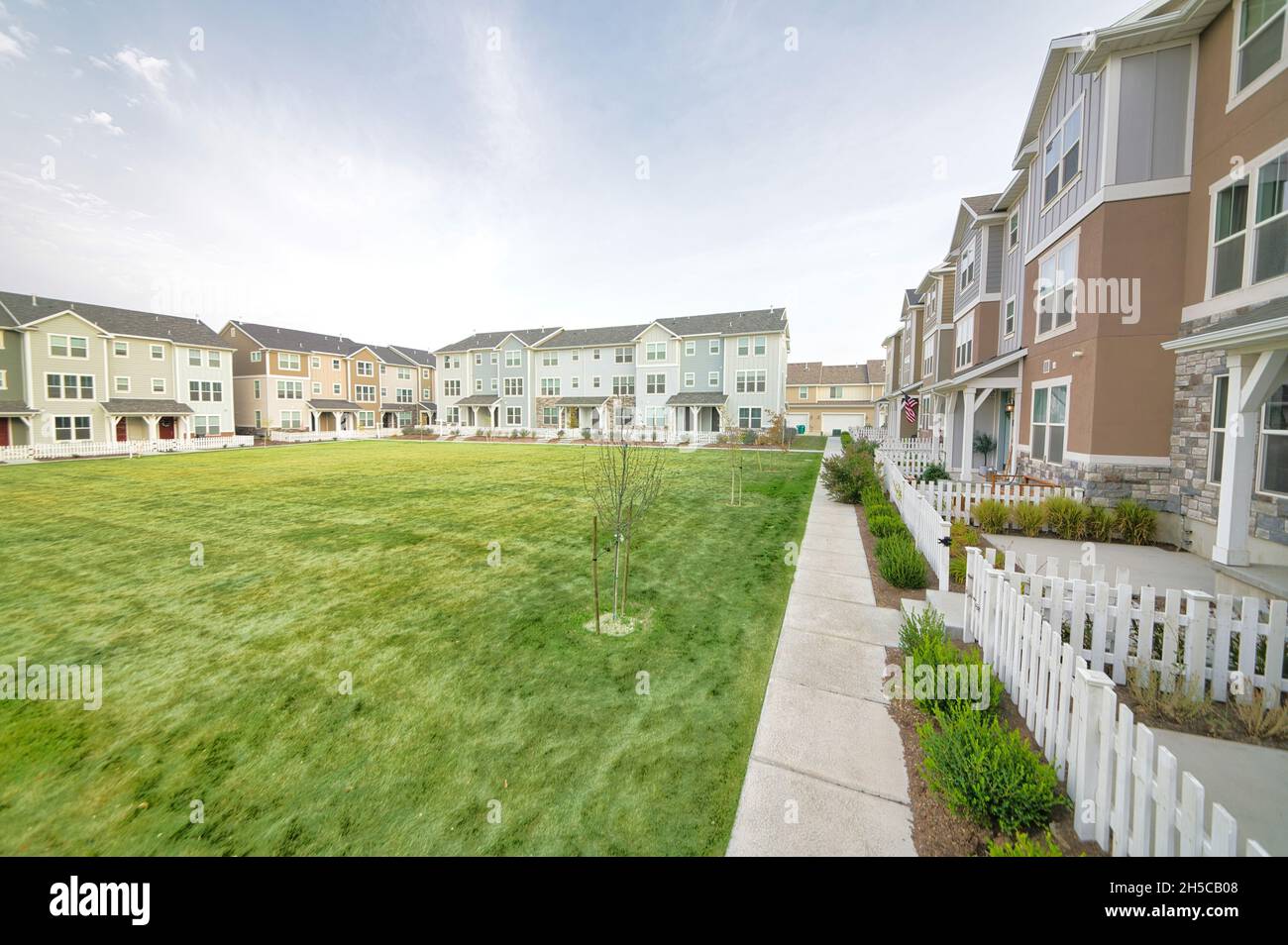 Large lawn field in the middle of townhouse buildings Stock Photo - Alamy