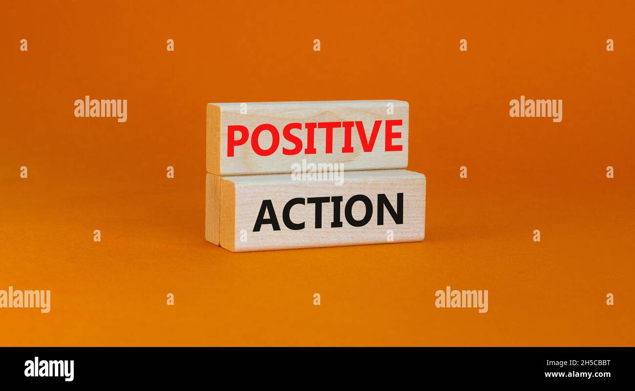Time to positive action symbol. Wooden blocks with concept words ...