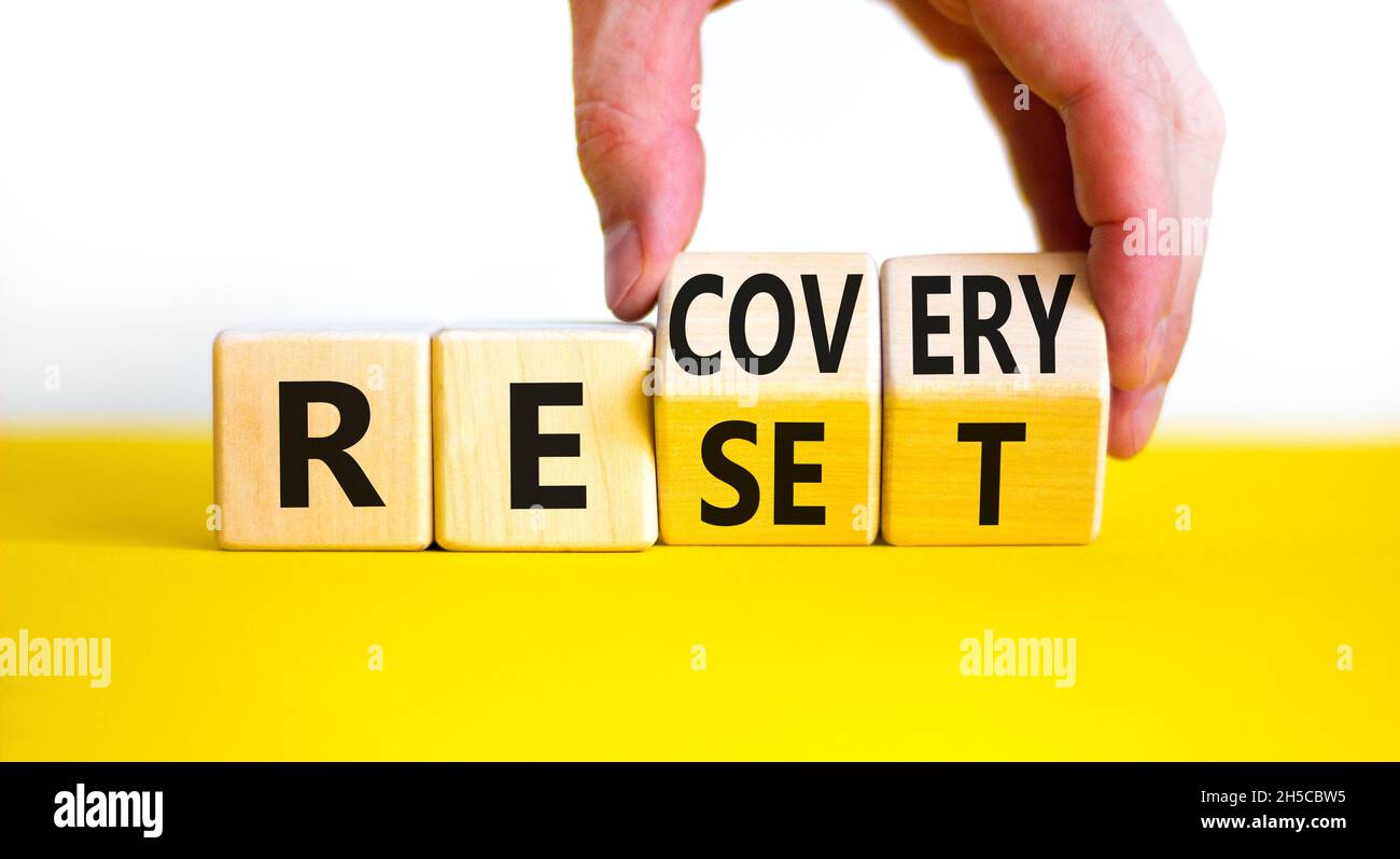 Recovery and reset symbol. Businessman turns cubes and changes the word ...