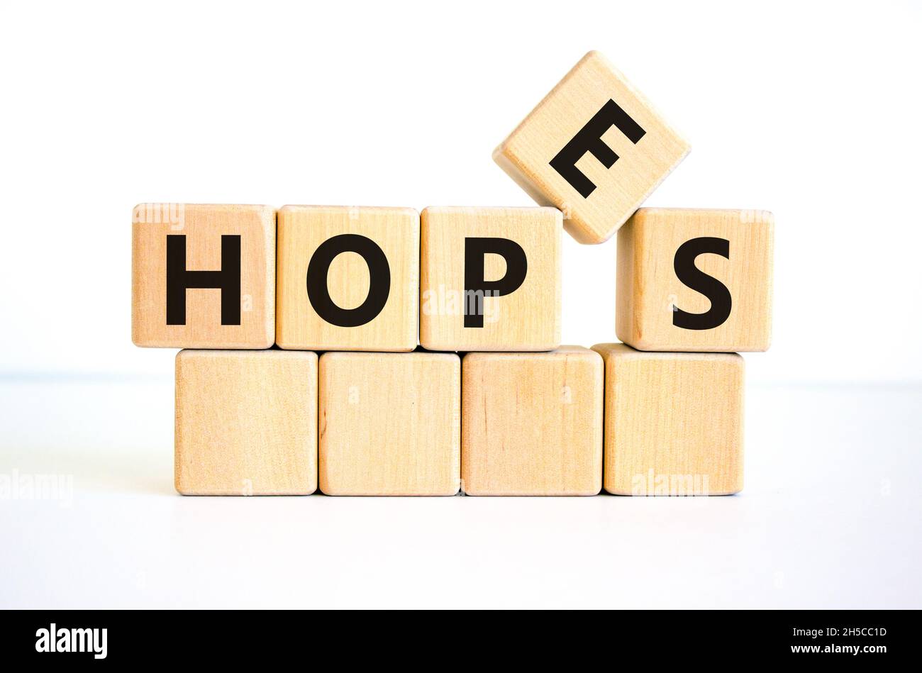 Hopes symbol. The concept word 'hopes' on wooden cubes. Beautiful white ...