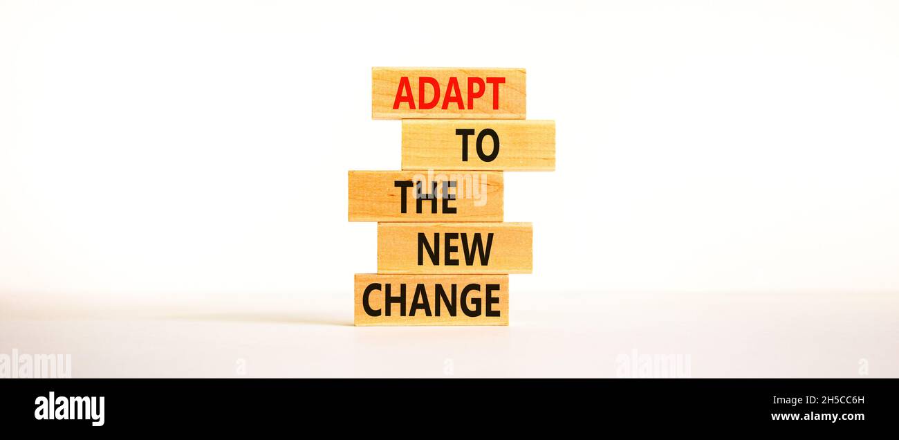 Adapt to the new change symbol. Wooden blocks with words Adapt to the ...