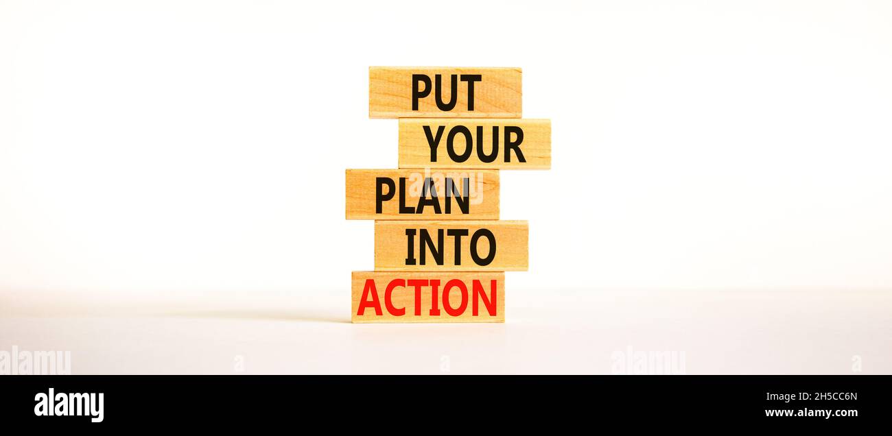 Put your plan into action symbol. Wooden blocks with words Put your ...