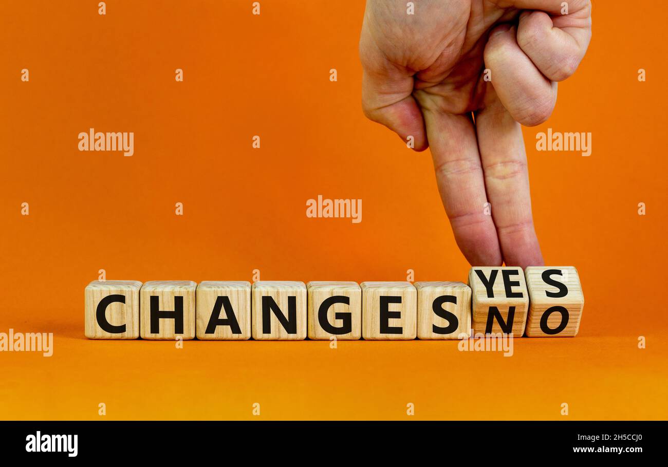 Changes yes or no symbol. Businessman turns wooden cubes and changs ...