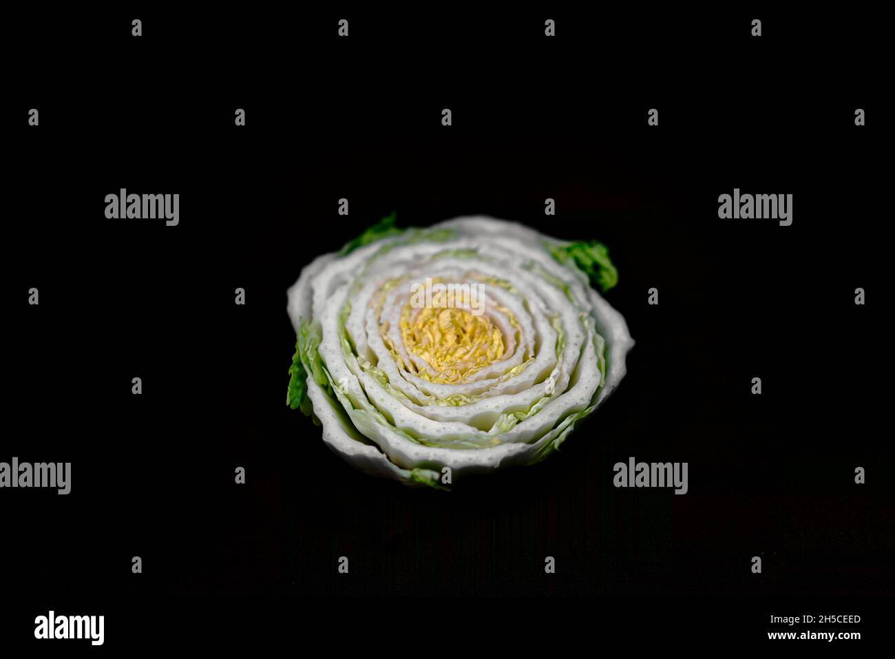 Chinese cabbage cut in half isolated on a black background Stock Photo ...