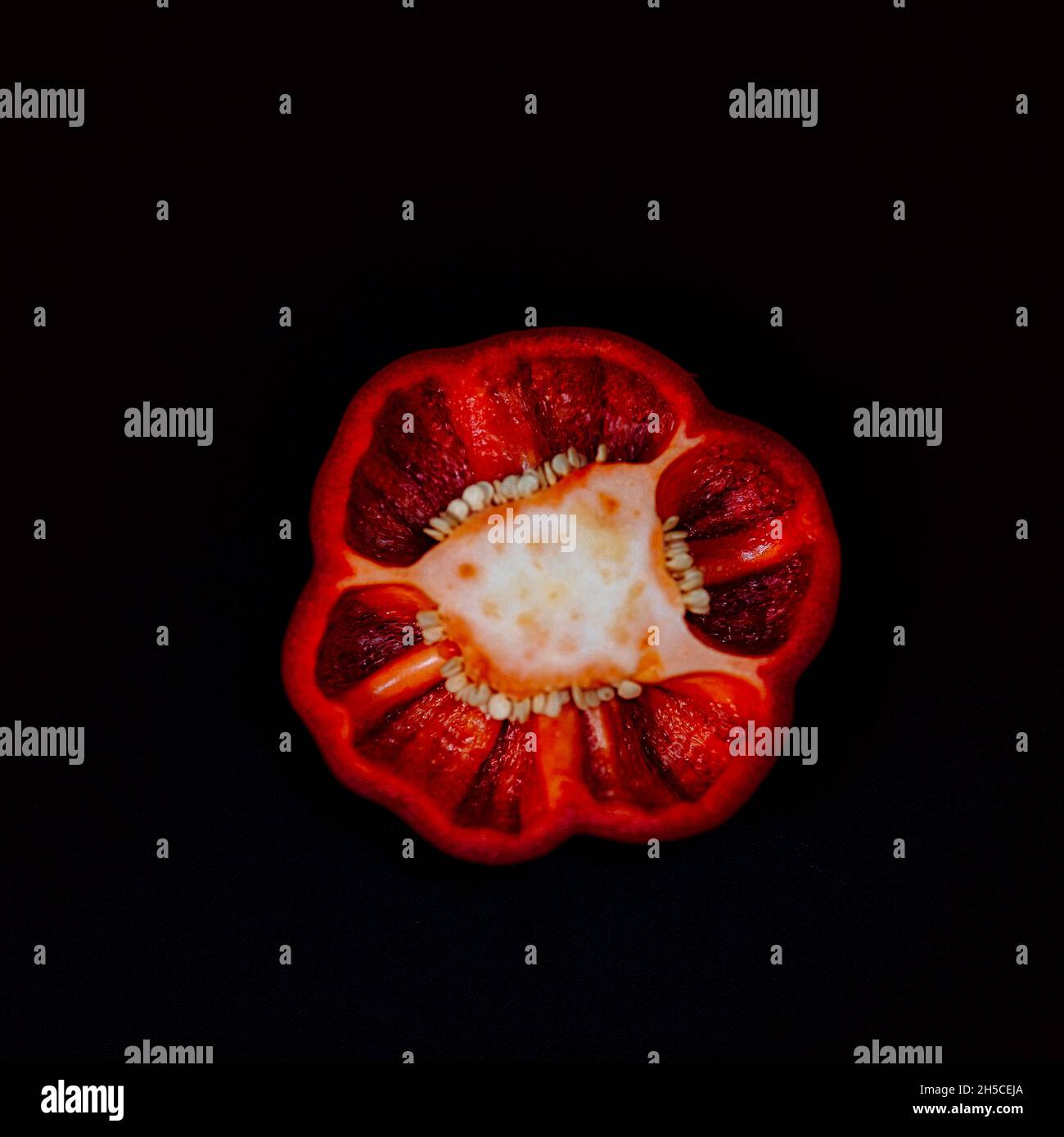Red bell paper cut in half isolated on a black background Stock Photo ...