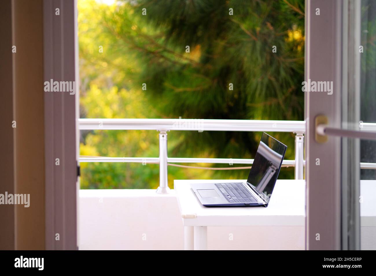 Laptop computer on the balcony table. Home office Stock Photo - Alamy
