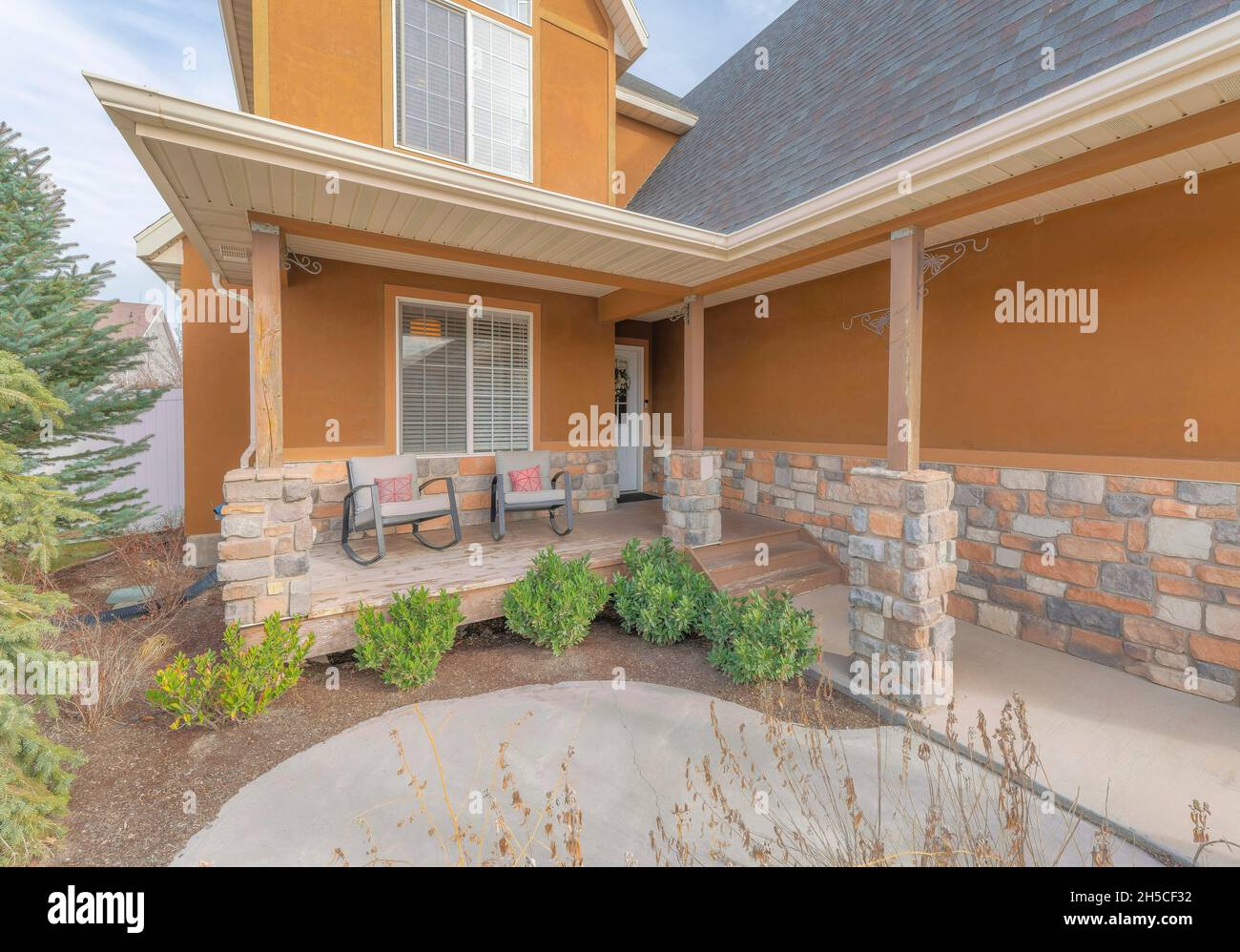 Orange tan house exterior with stone veneer sidings Stock Photo - Alamy