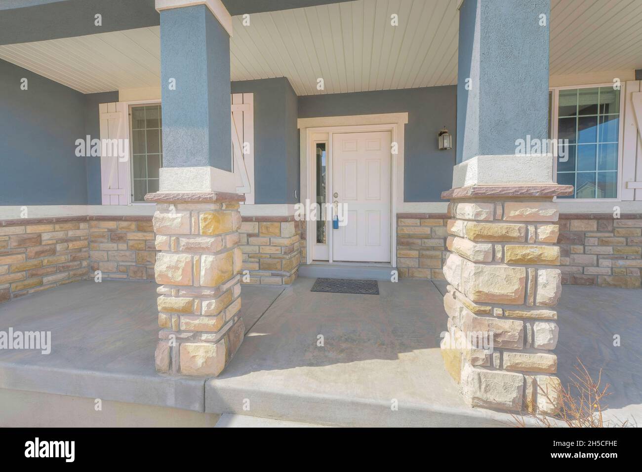 White front door exterior of a house with lockbox and windows with fake ...