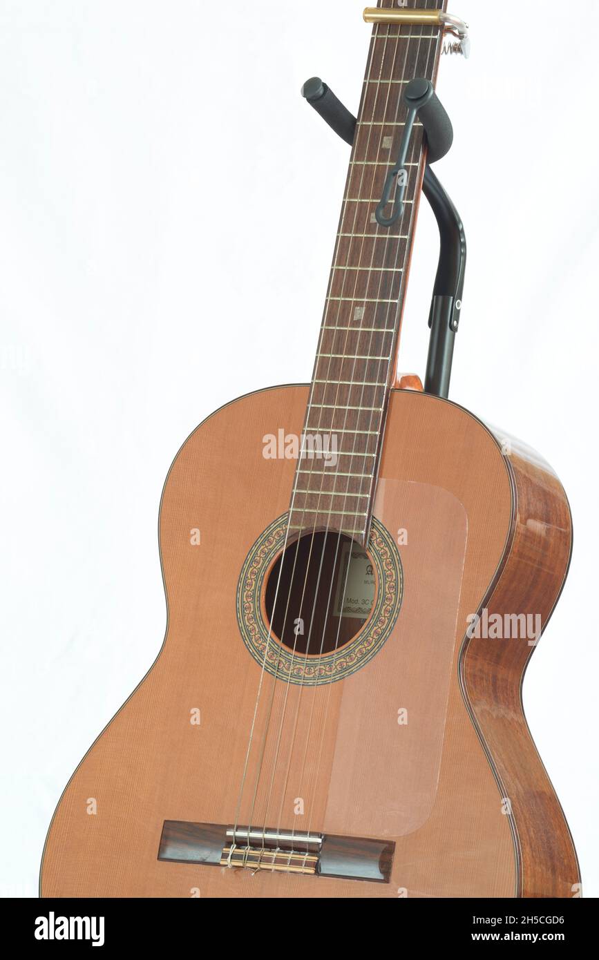 Closeup of a spanish guitar on a universal portable vertical guitar ...
