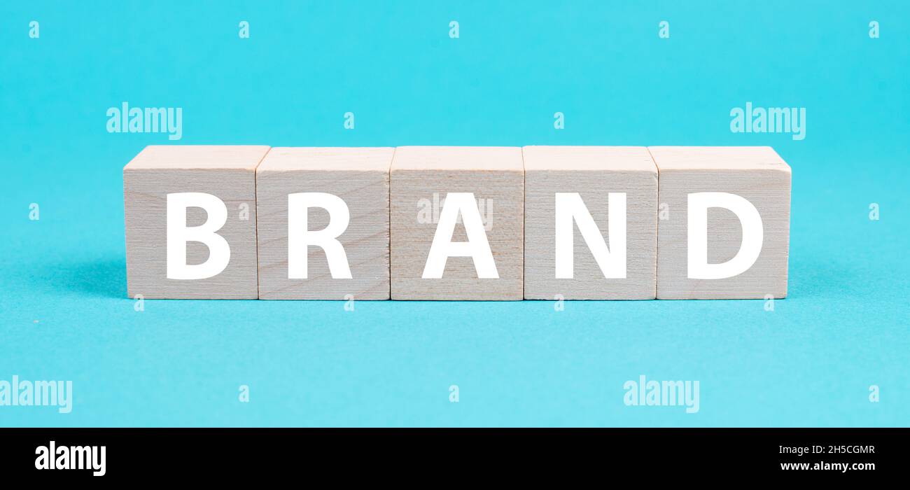 The word brand is standing on wooden cubes, positioning of a company ...