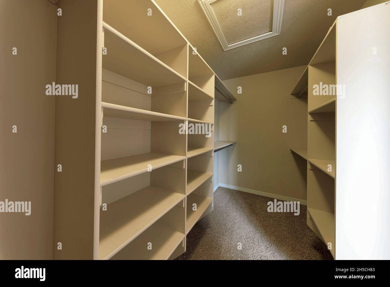 Empty walk-in closet with framed shelves and metal rods Stock Photo - Alamy