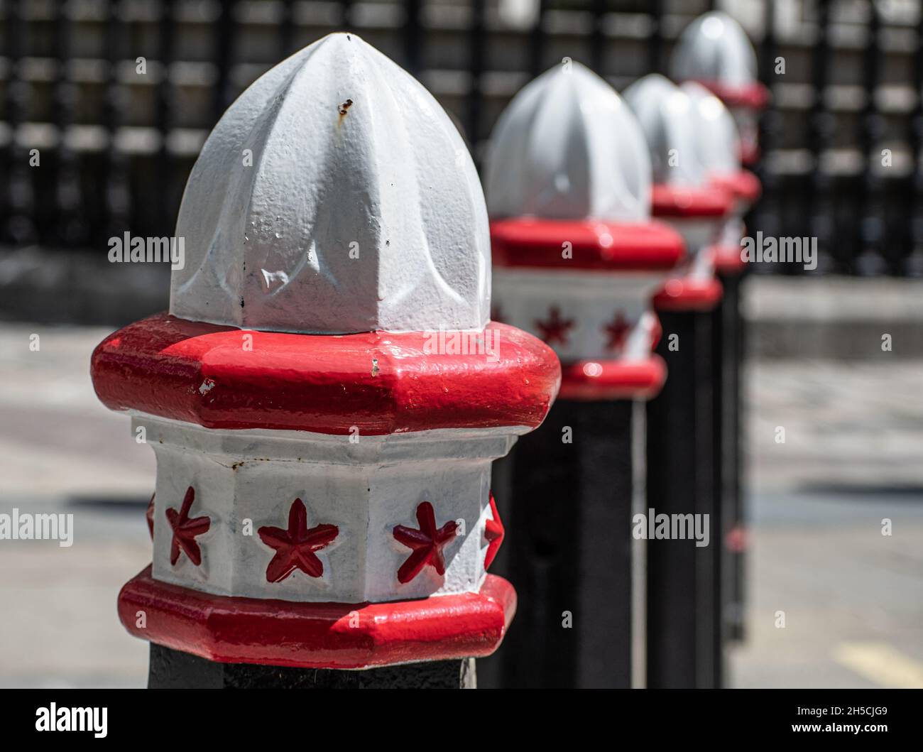 Bright red, white and black bollards Stock Photo - Alamy