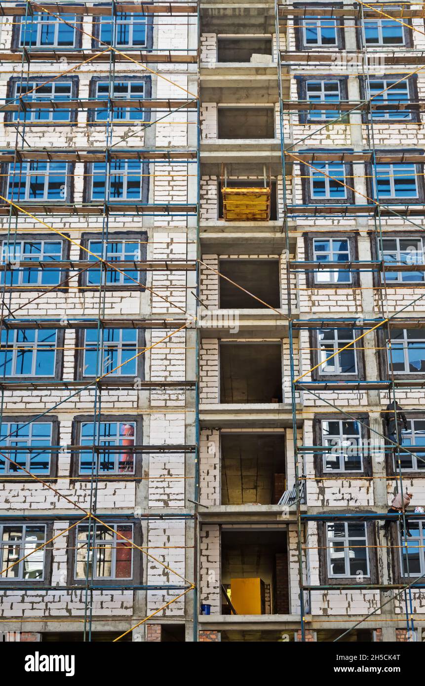Modern building under construction. Wall of multi-storey building under ...