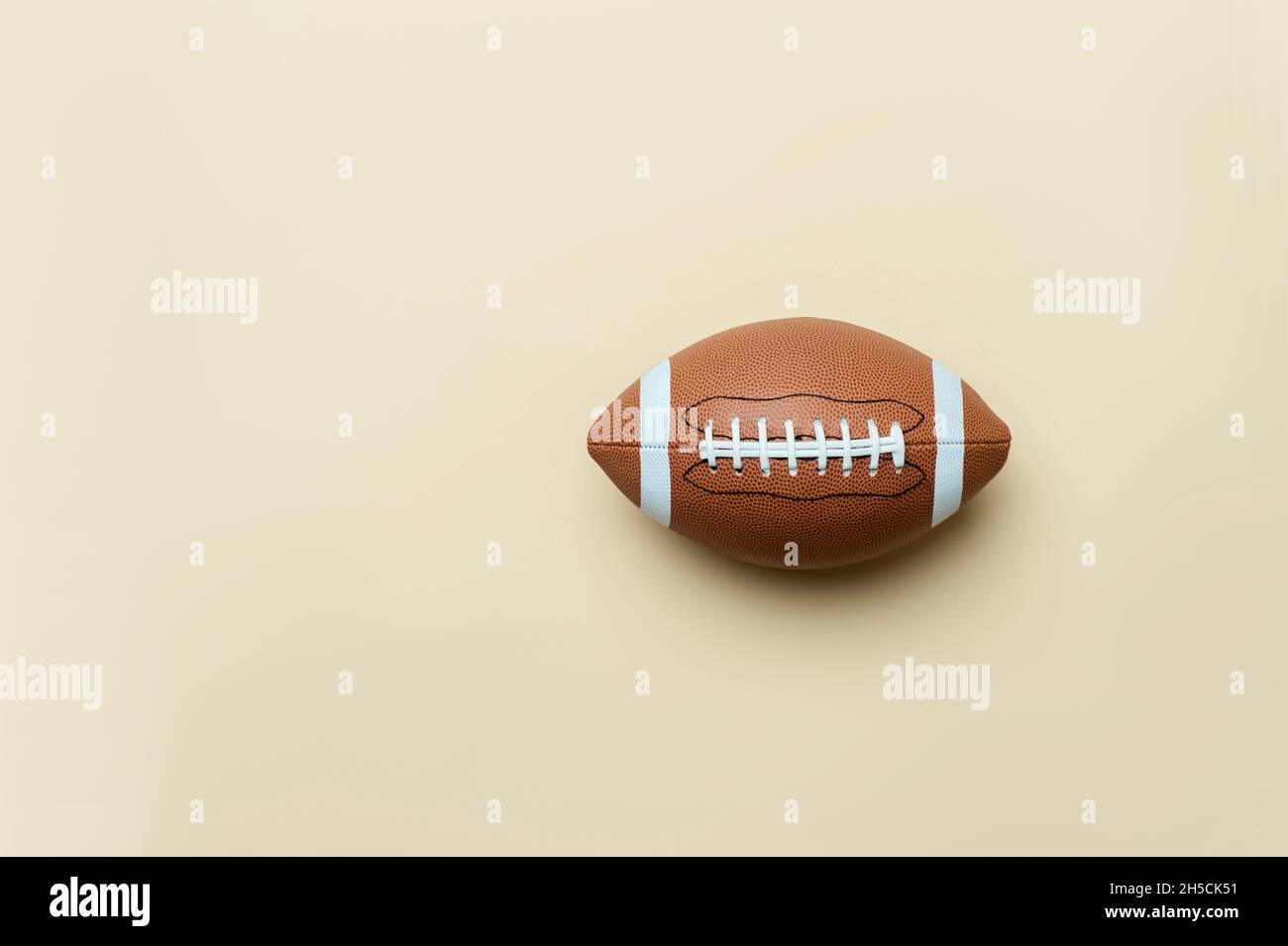 Leather american football on beige background. Sport team concept ...