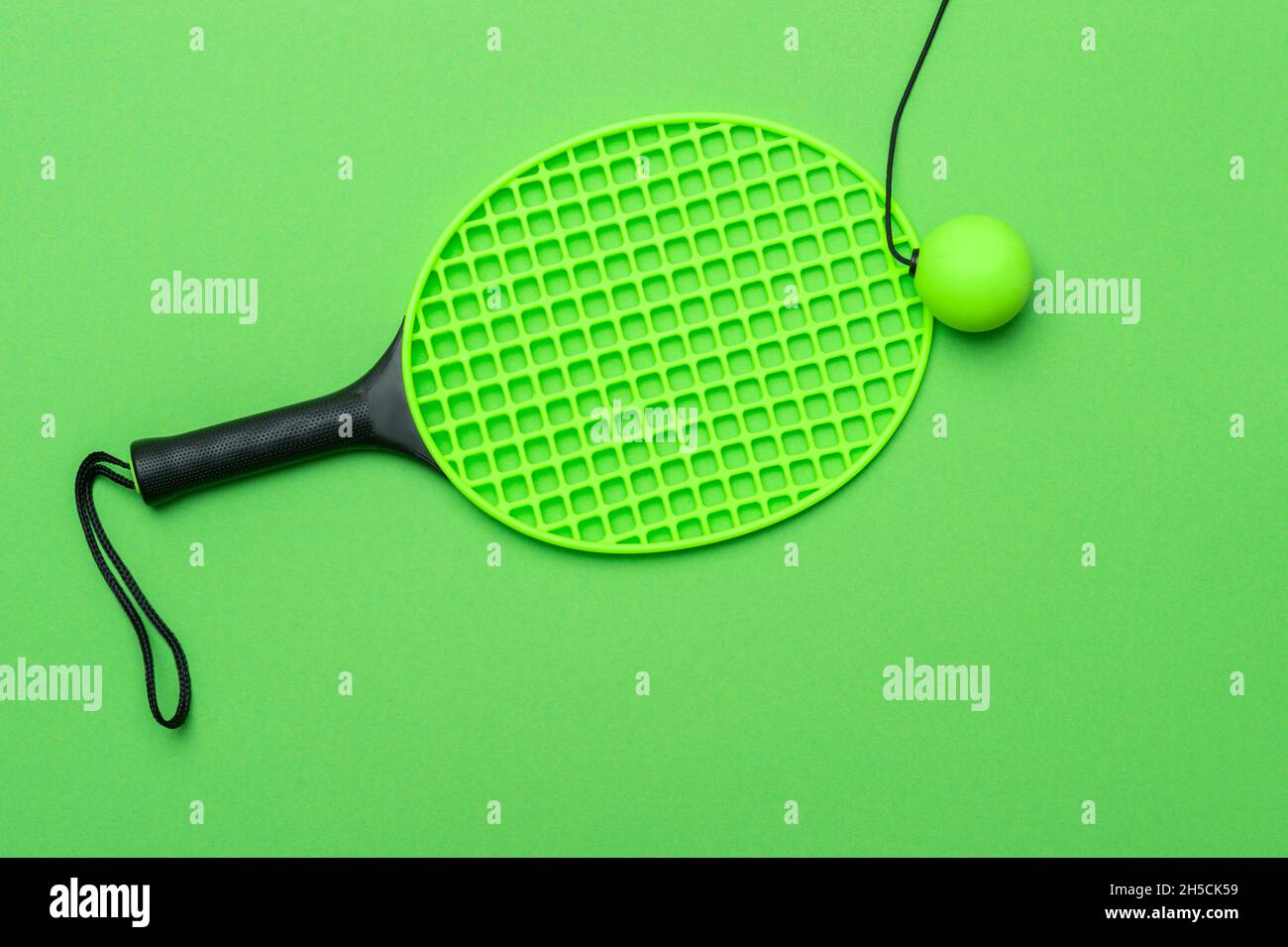 Green speedball racket and ball on green background. Horizontal sport ...