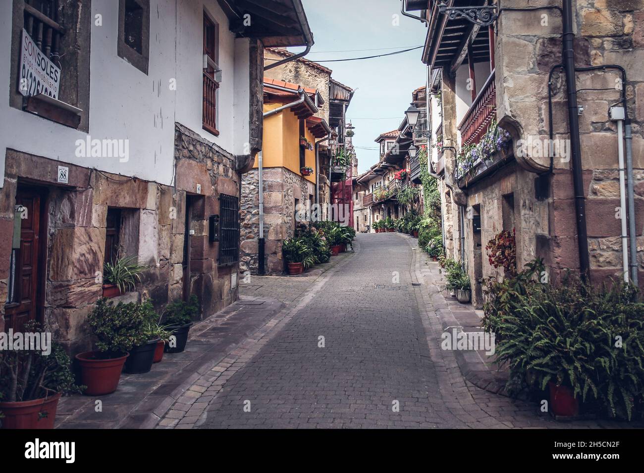 Scenic view of a street in between houses in a town Stock Photo - Alamy