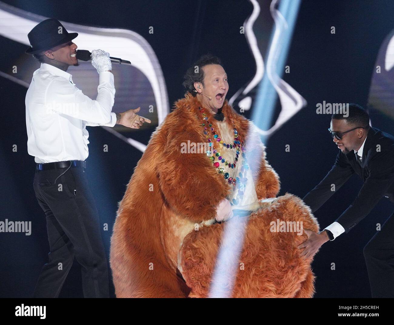 THE MASKED SINGER, host Nick Cannon (left), Hamster (center - revealed ...
