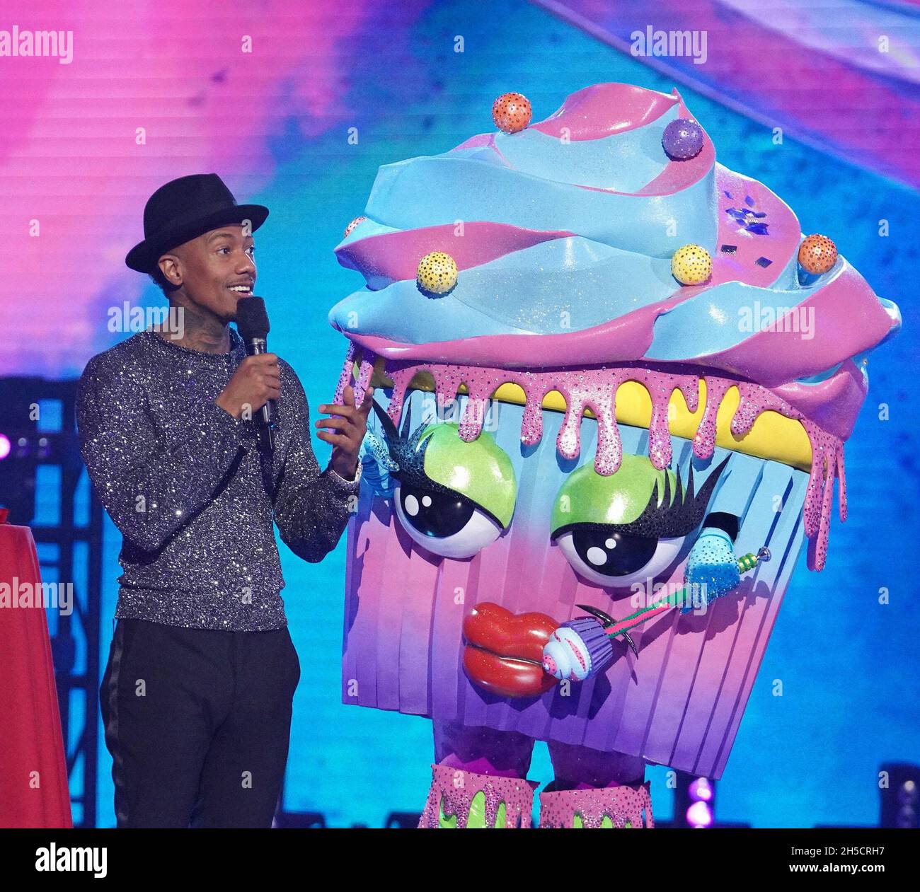 THE MASKED SINGER, from left: host Nick Cannon, Cupcake, 'Date Night ...