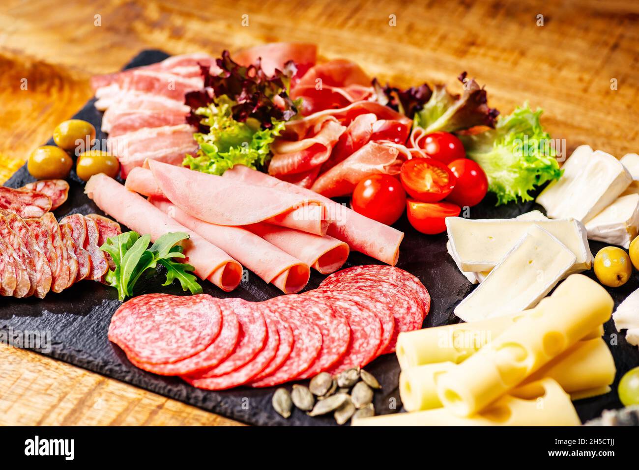 Top view.Various types of meat and sausages on wooden table.Assorted ...