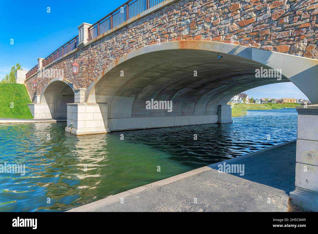 Double arched bridge with stone walls and railings over the Oquirrh ...