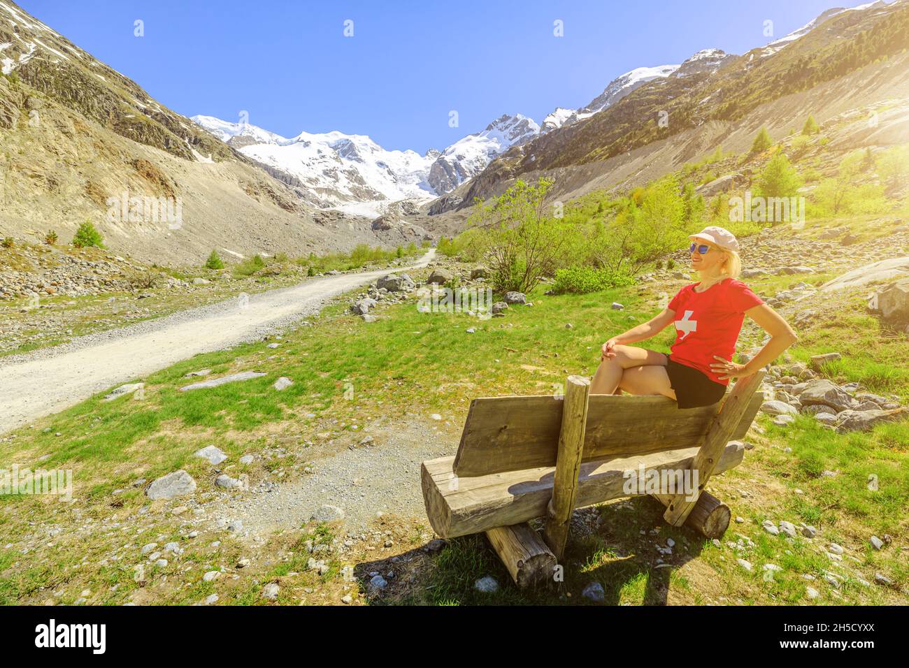 Woman with swiss flag t-shirt on the trekking trail to Morteratsch ...