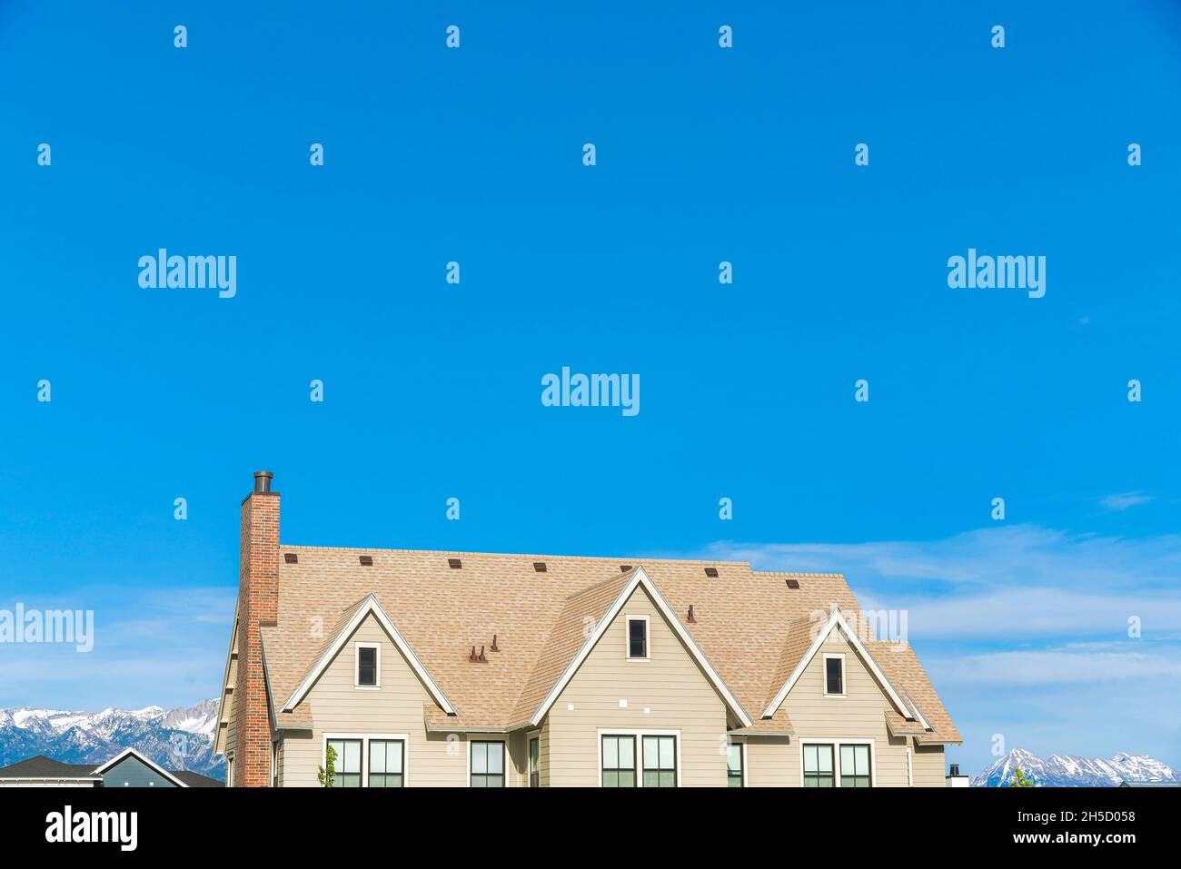 Exterior of a house with beige siding and asphalt composite shingle ...