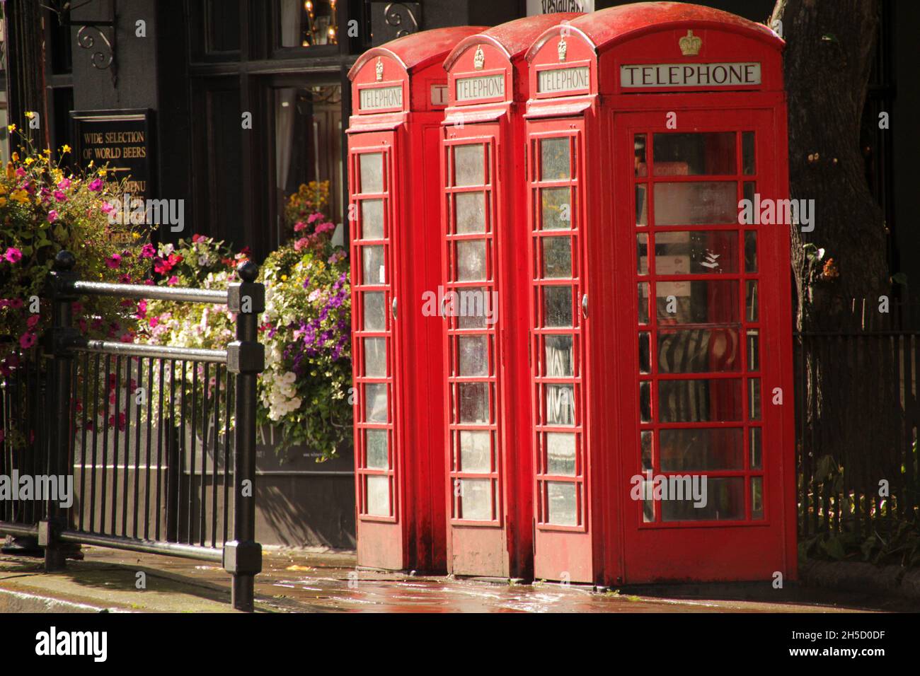Three famous english red phone booths in the row in London on a sunny ...