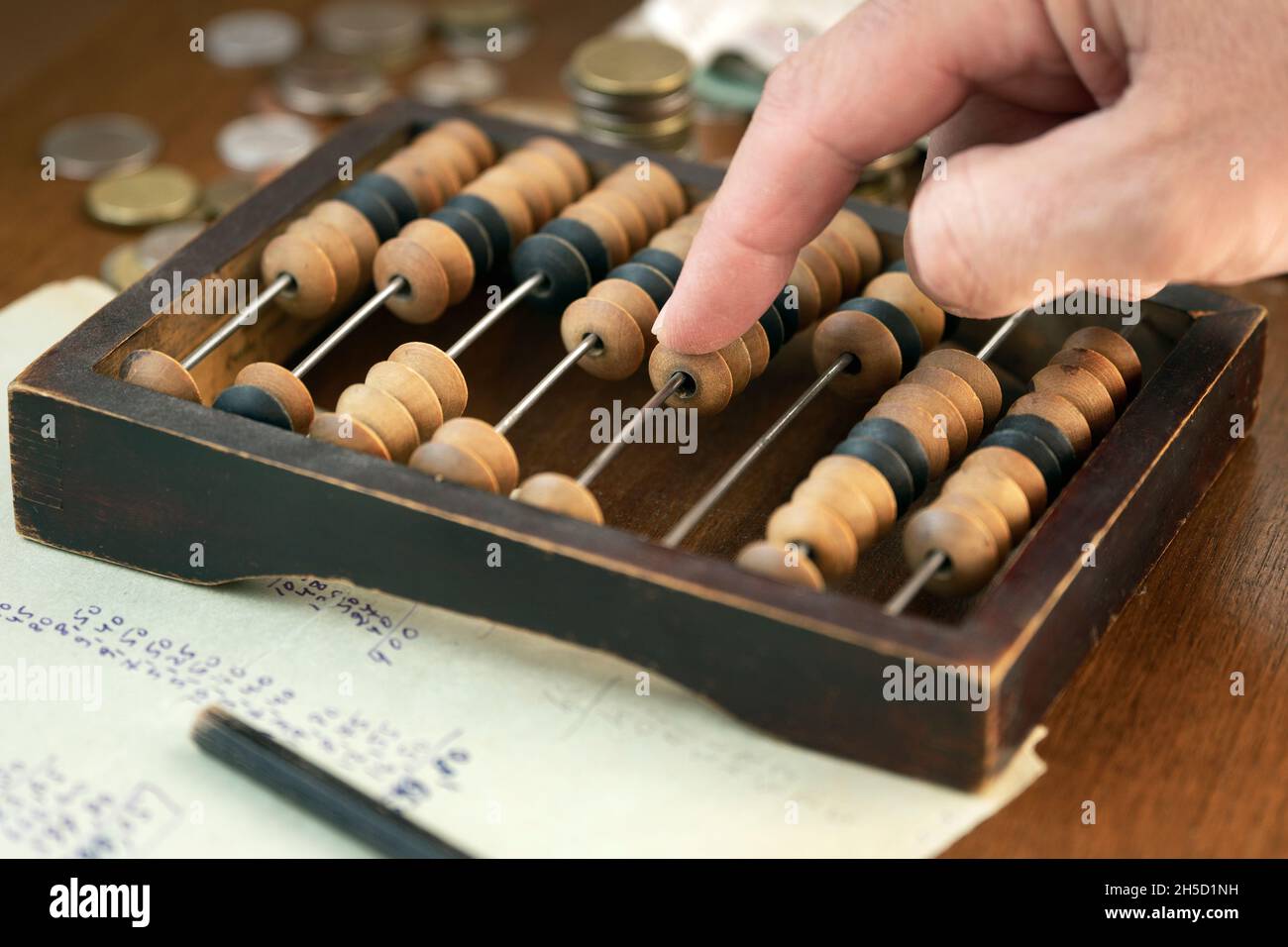 Accountant's hand counting money using vintage wooden abacus with old ...