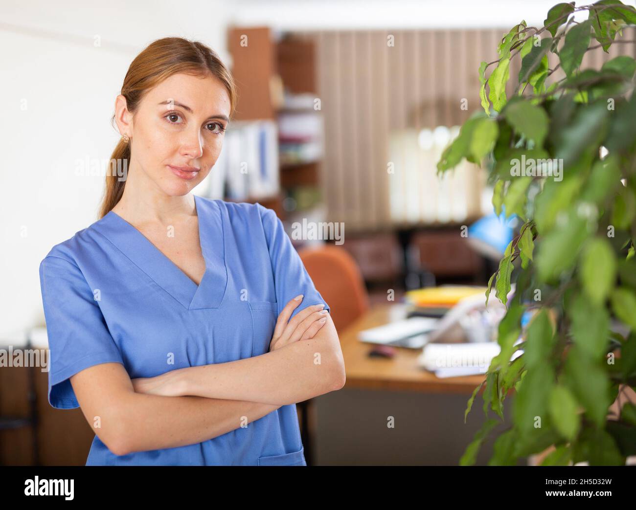Nurse standing in hall of clinic Stock Photo - Alamy