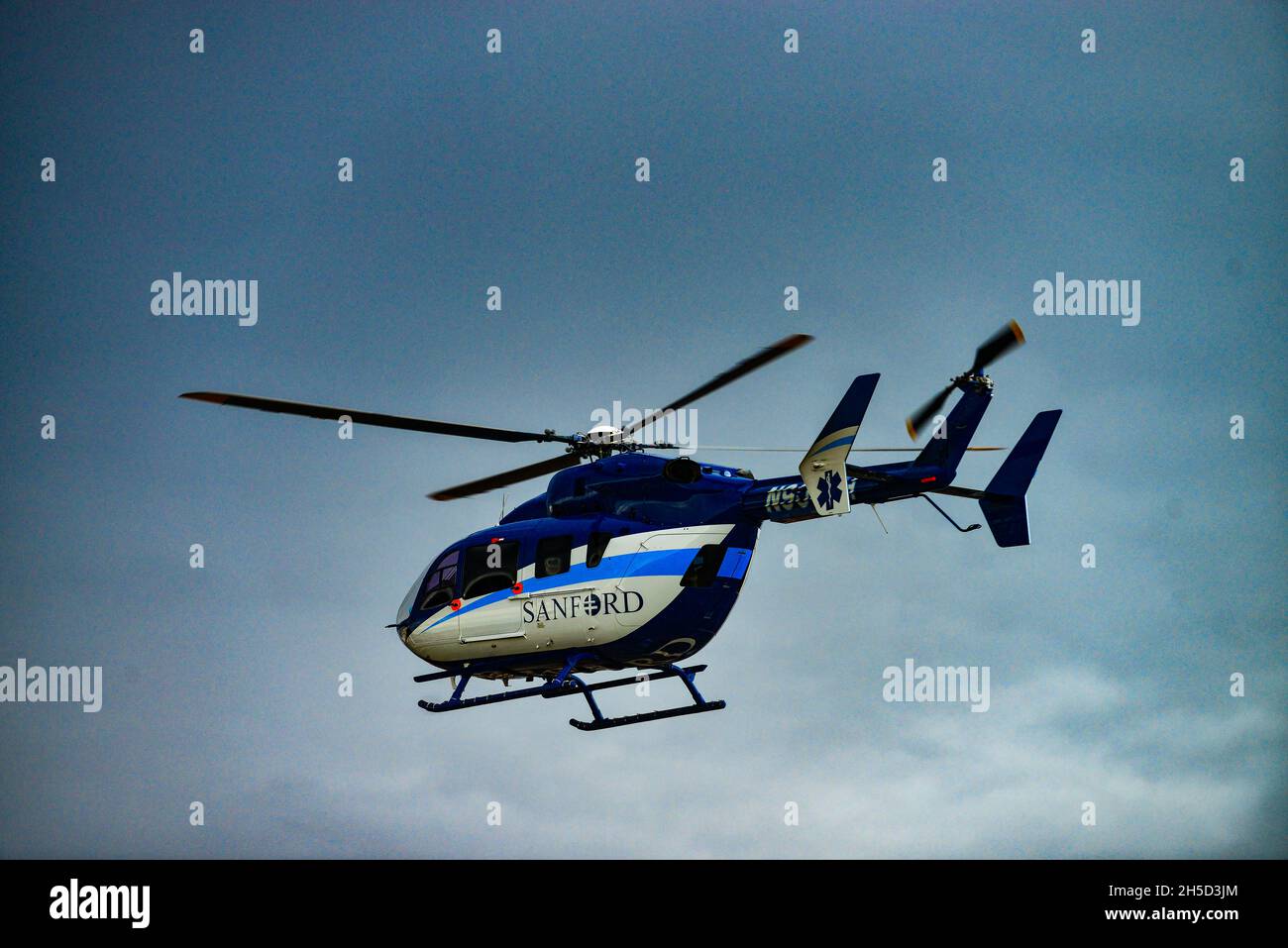 Medical helicopter in flight departing hospital Stock Photo - Alamy