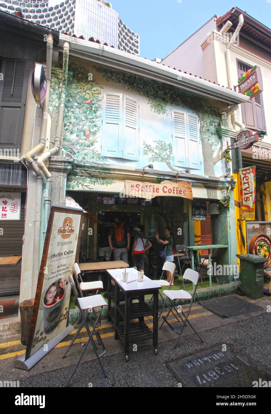 A coffee shop called Selfie Cafe with painted front facade and people ...