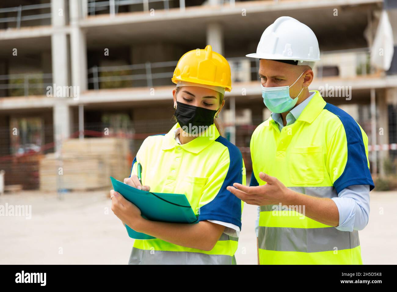 Civil engineers in masks checking work process Stock Photo - Alamy