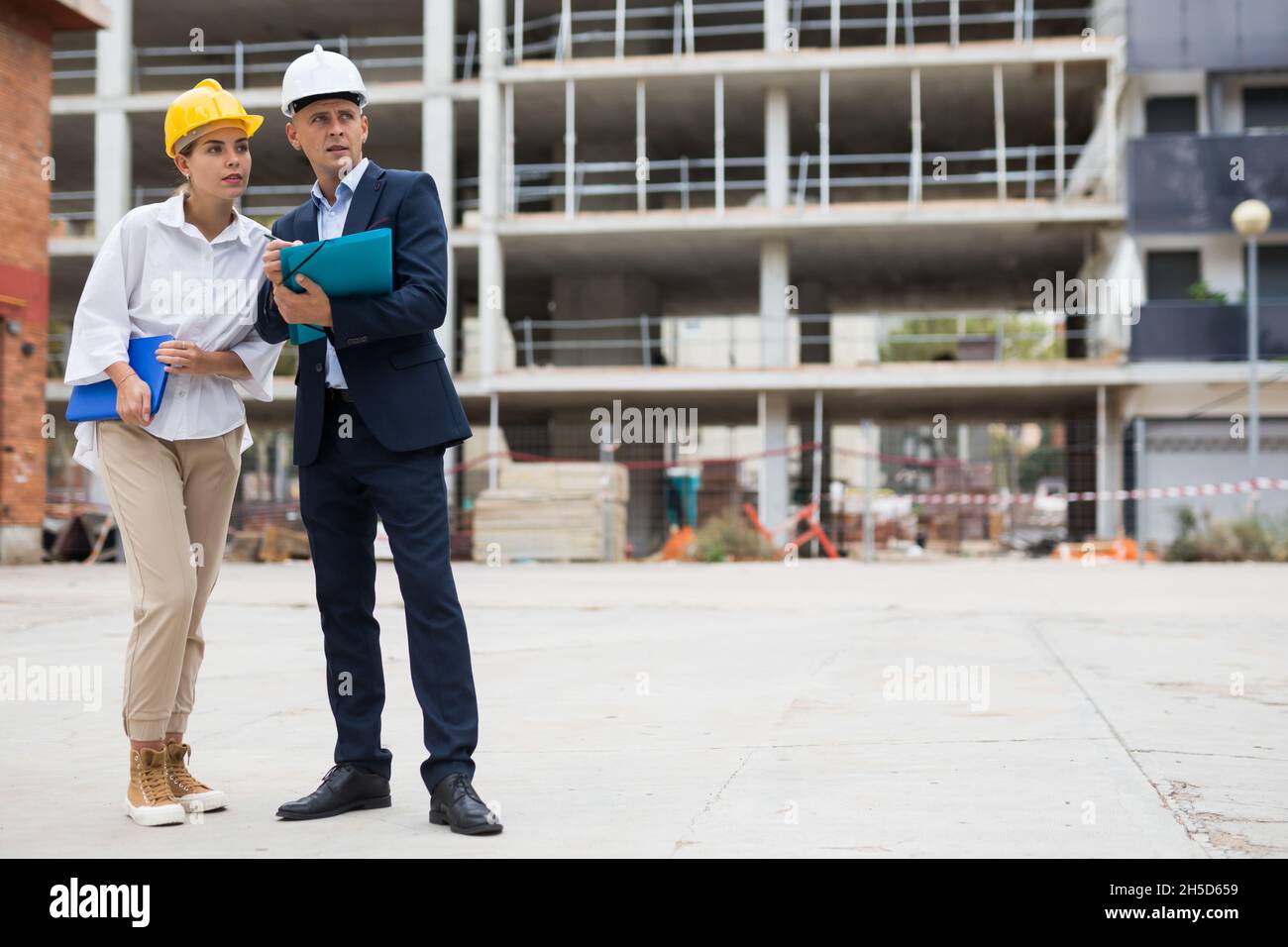 Civil engineers checking work process in construction site Stock Photo ...