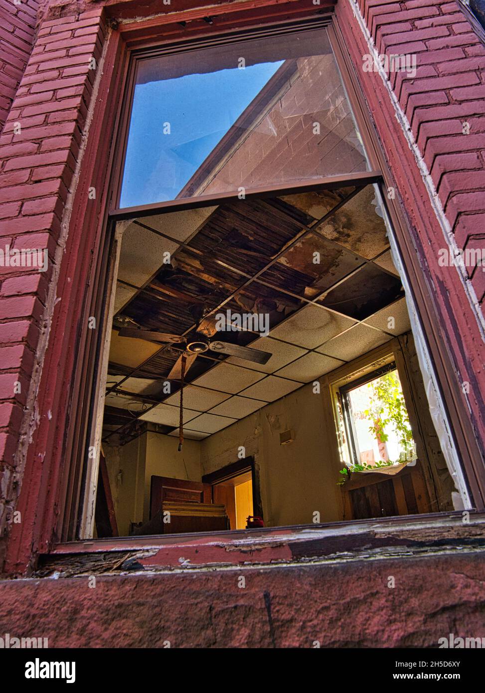 Unique window looking inside of an abandoned brick house showing the ...