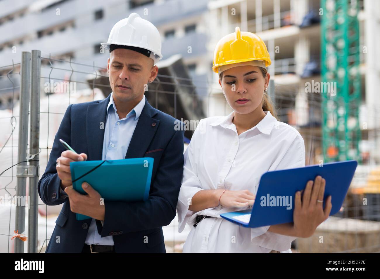 Man and woman engineers planning project of new building Stock Photo ...