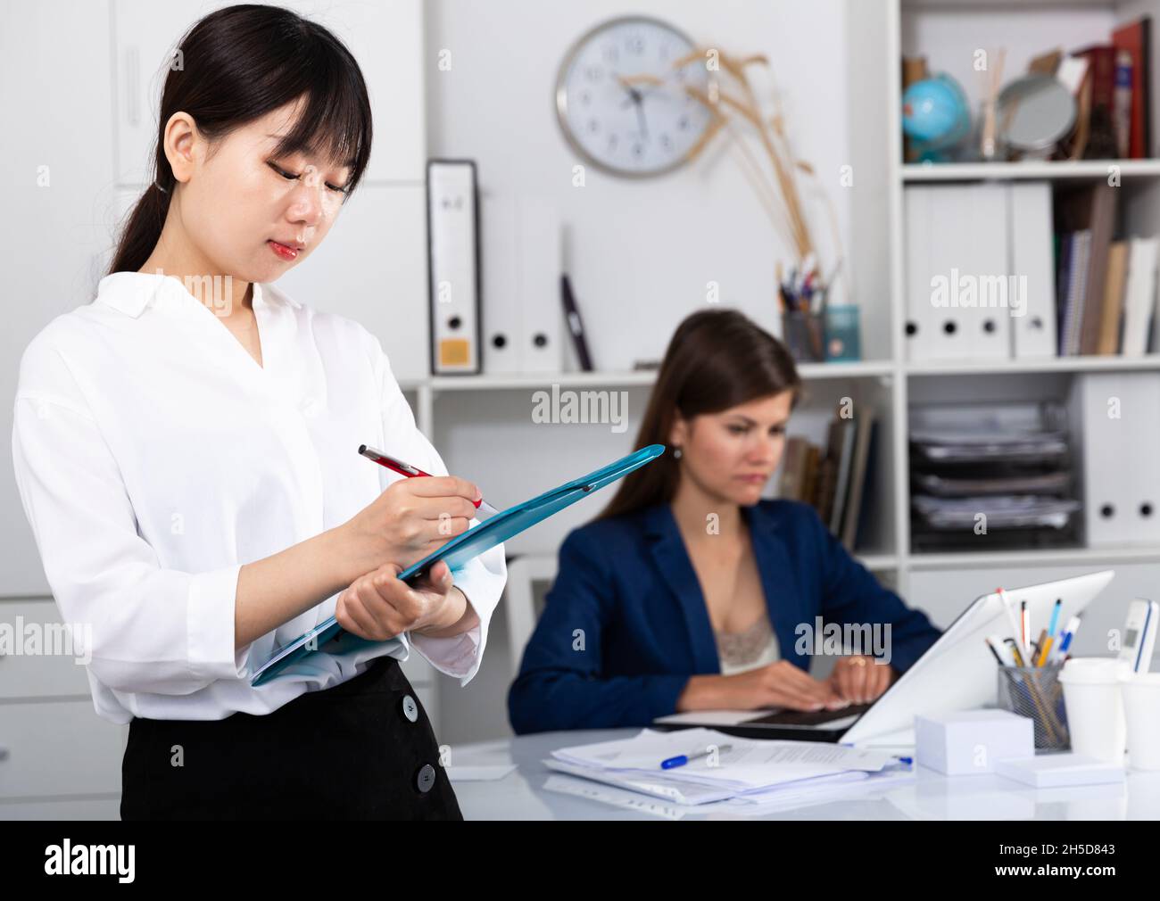 Portrait of successful confident chinese business woman in office ...