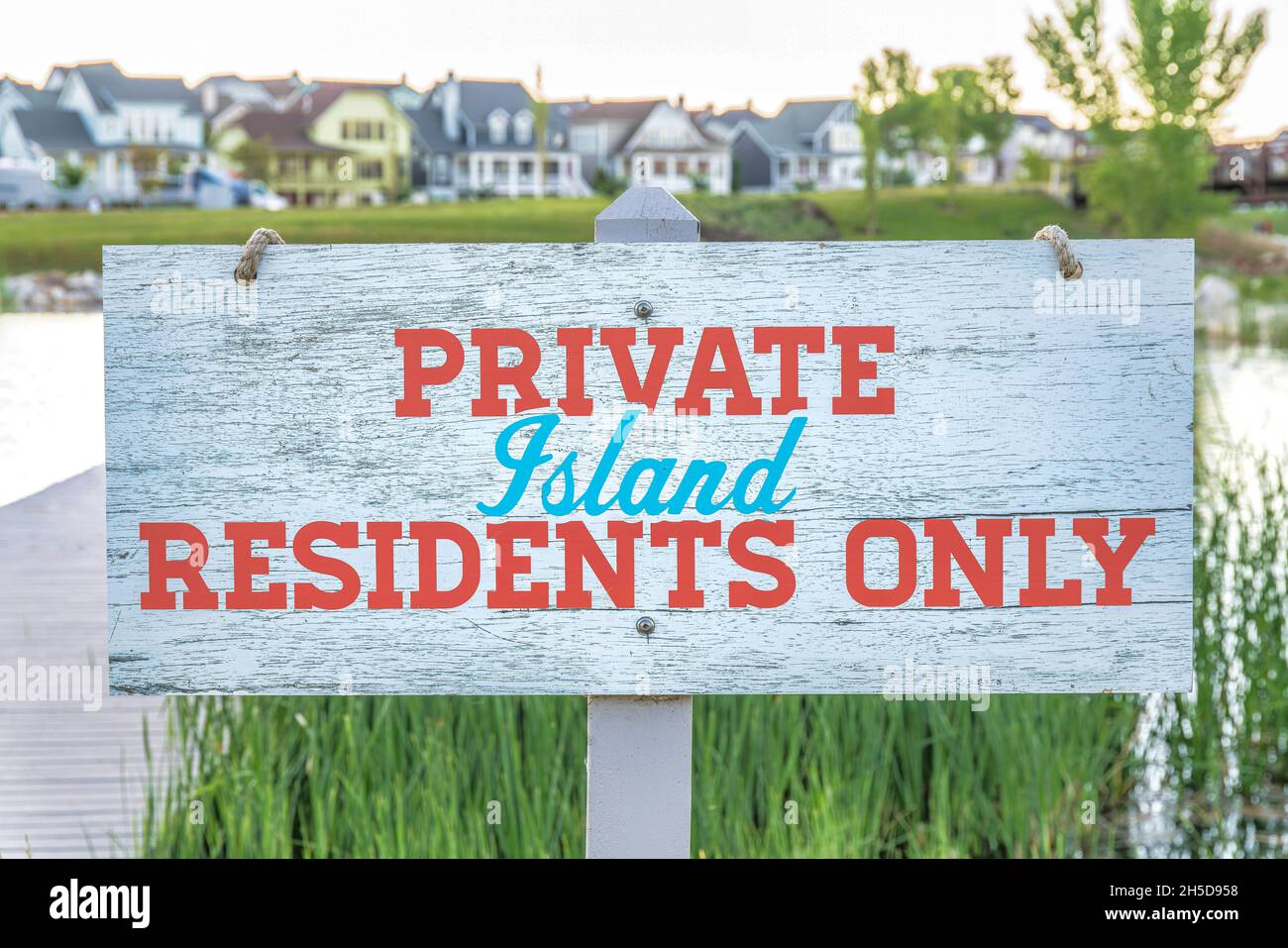 Signage saying private island residents only on a white board post at ...