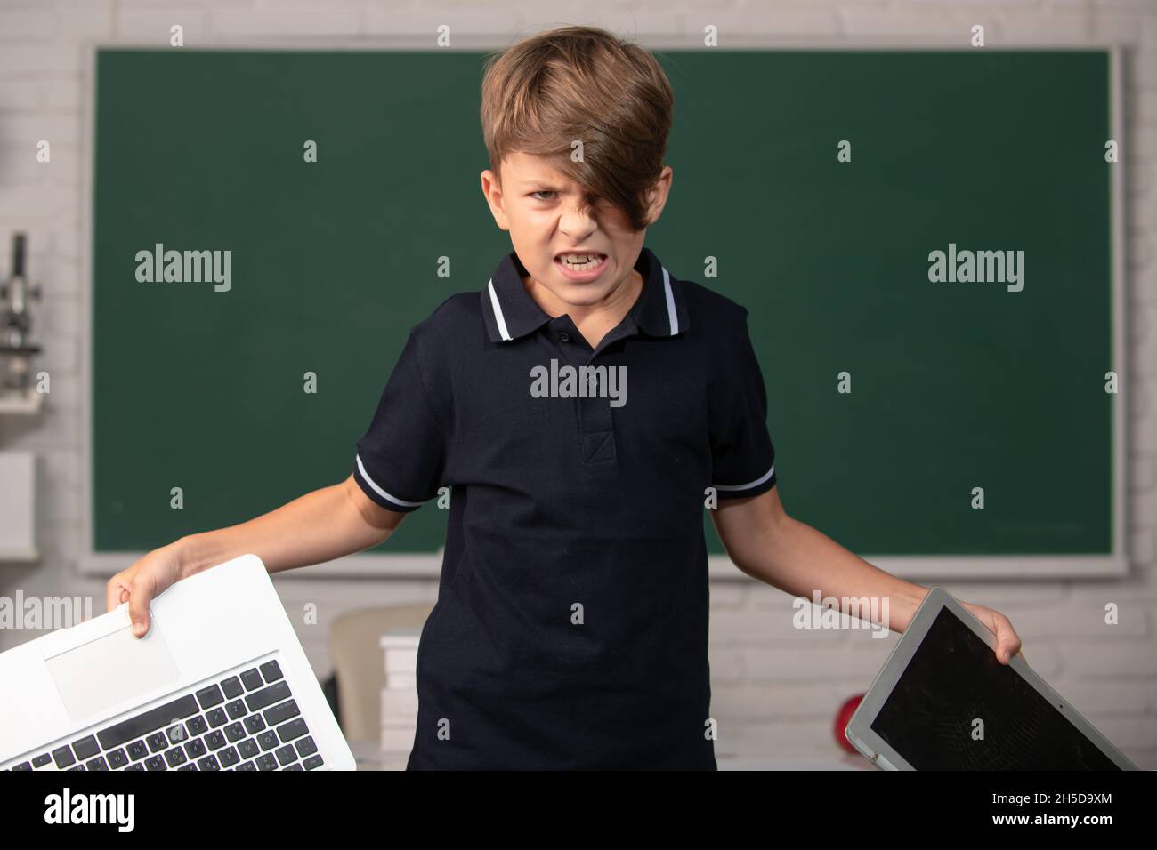 Angry boy in opposition distance education. School kid broken online ...