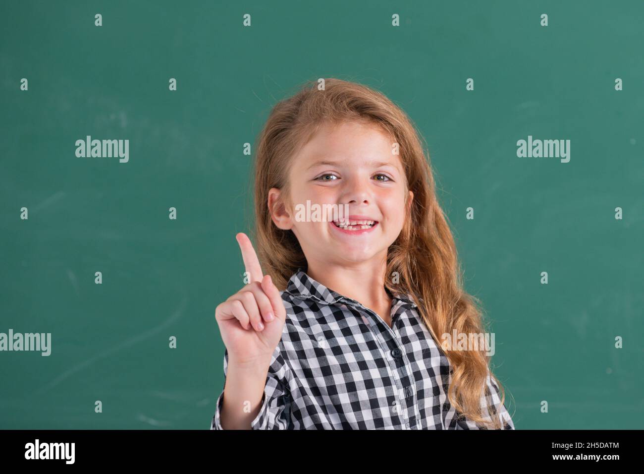 Portrait of school girl nerd pupil with surprising expression pointing ...